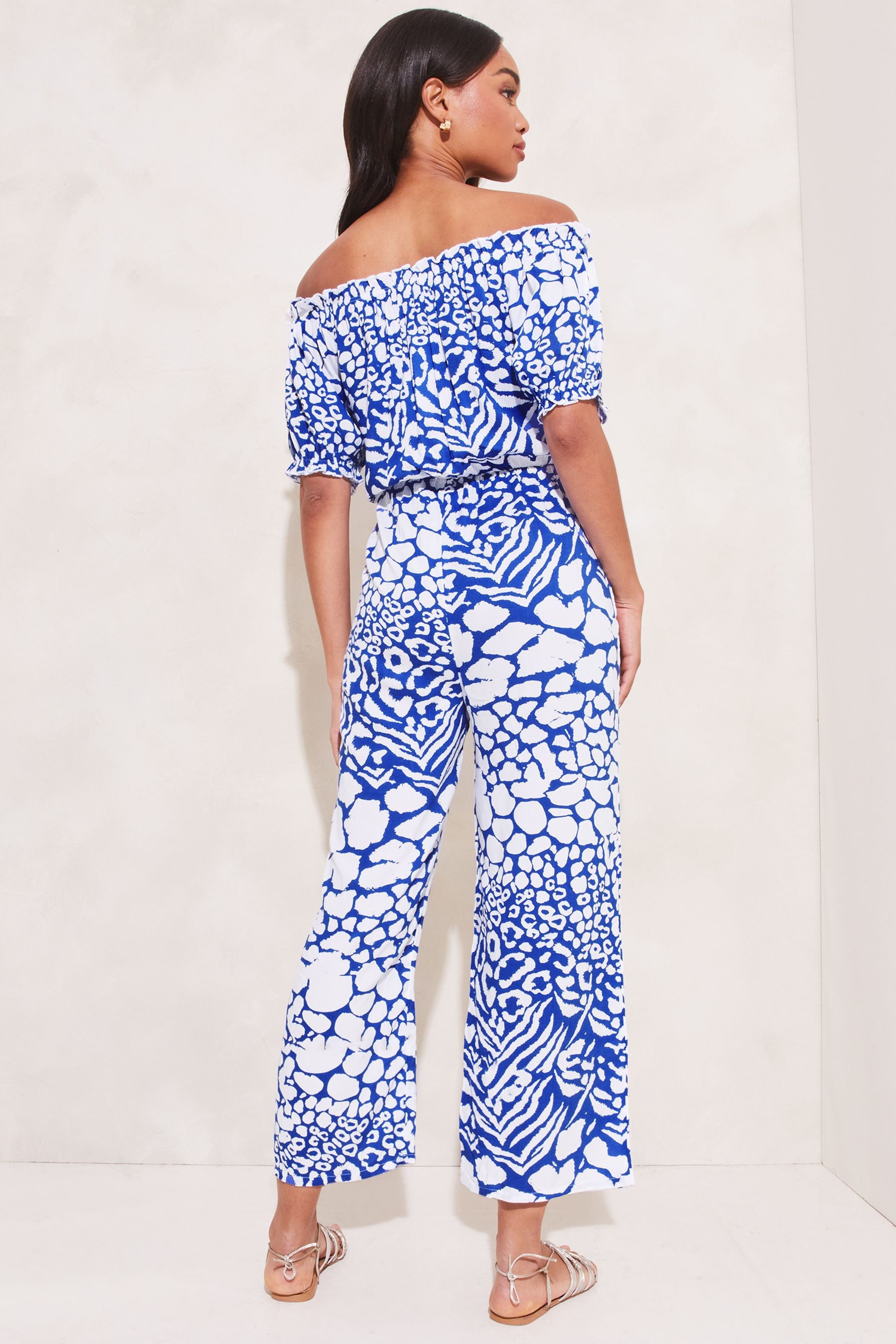 Buy Lipsy Blue Animal Printed Bardot Off Shoulder Puff Sleeve Jumpsuit ...