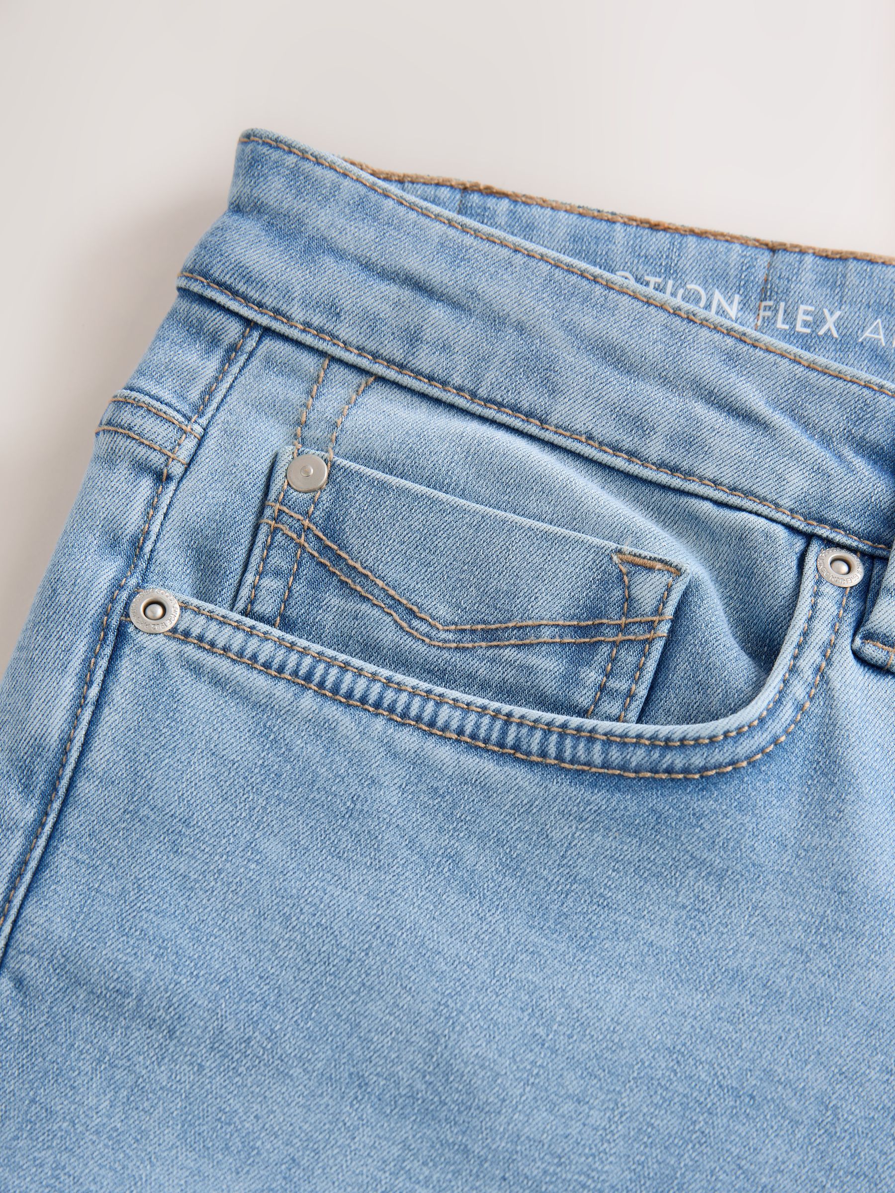 Buy Blue Light Slim Fit Lightweight Motion Flex Denim Jeans from the ...