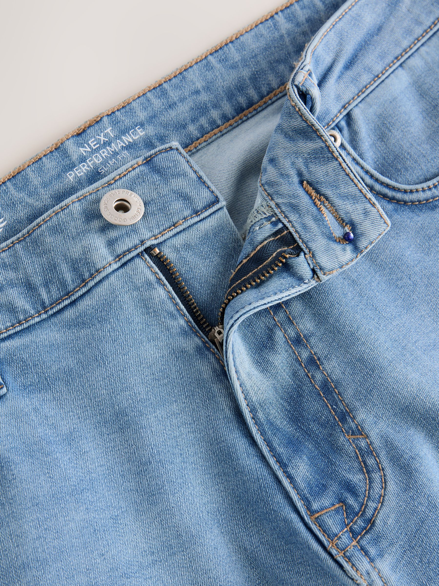 Buy Blue Light Slim Fit Lightweight Motion Flex Denim Jeans from the ...