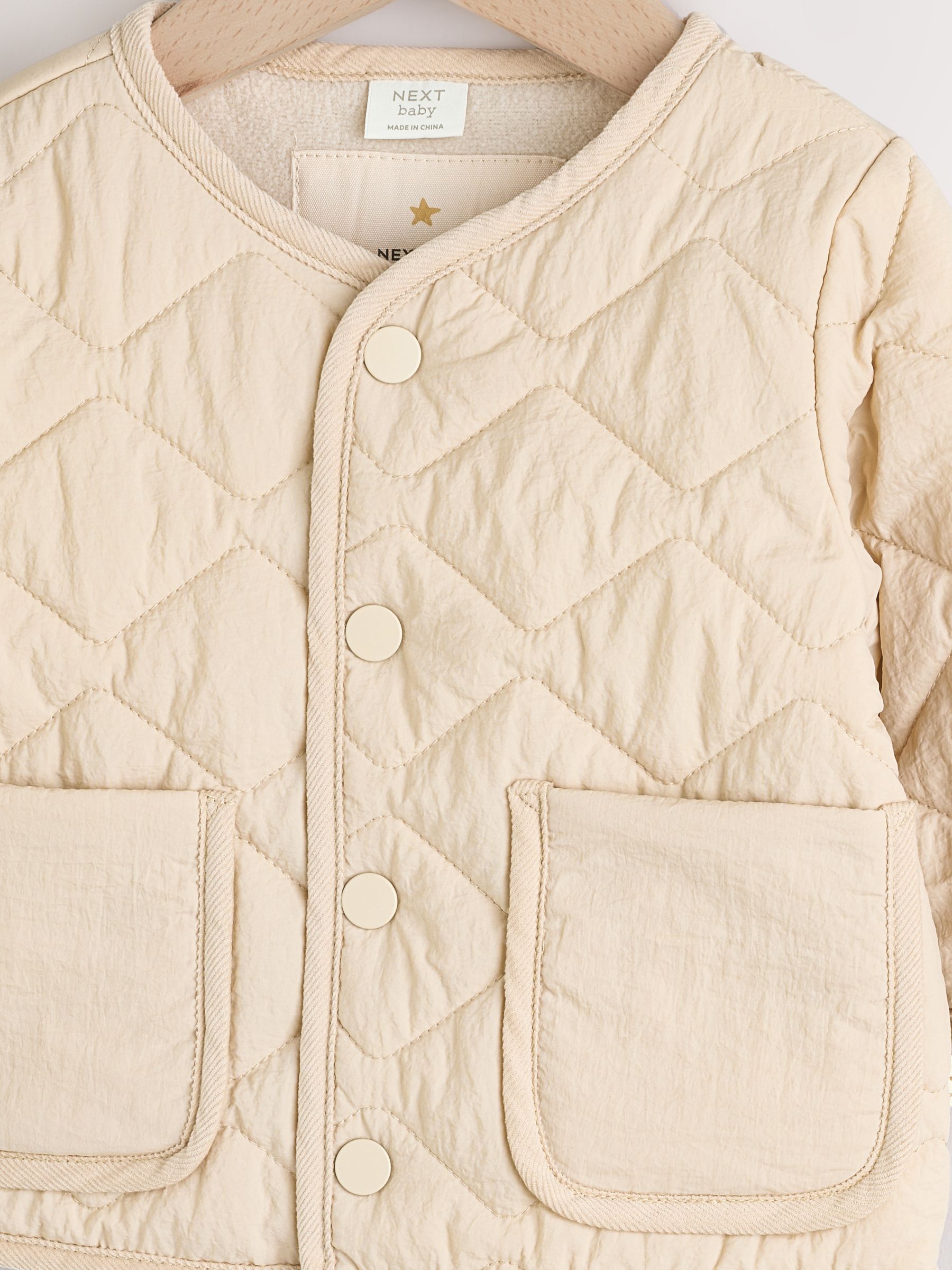 Buy Neutral Quilted Popper Baby Jacket from the Next UK online shop