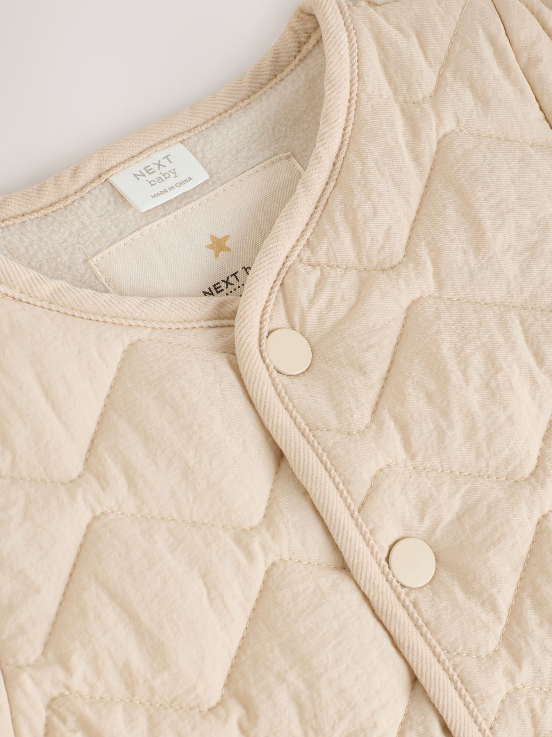 Buy Neutral Quilted Popper Baby Jacket from the Next UK online shop
