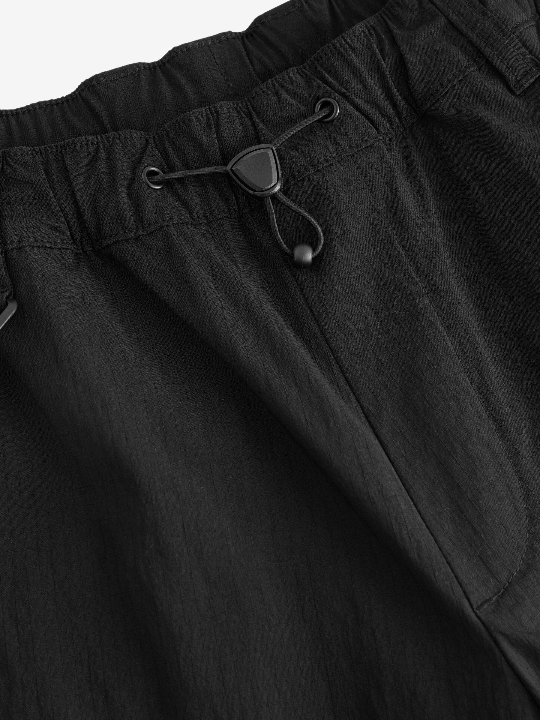 Buy Black Regular Fit Ripstop Tech Cargo Trousers from the Next UK ...