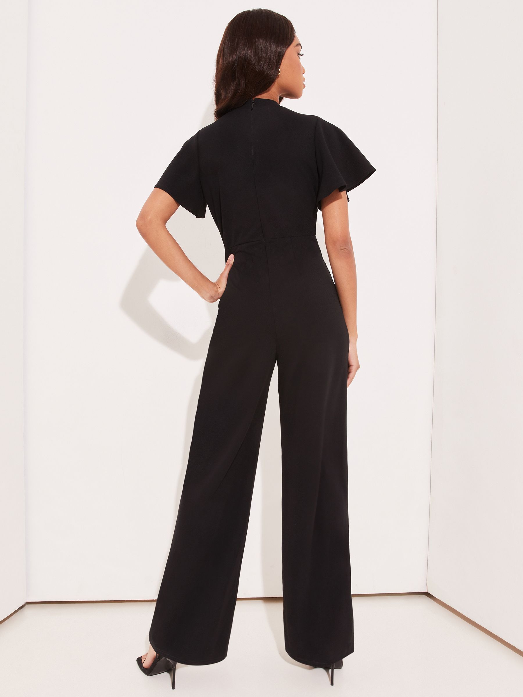 Buy Lipsy Black Flutter Sleeve V Neck Tie Front Wide Leg Jumpsuit from the Next UK online shop