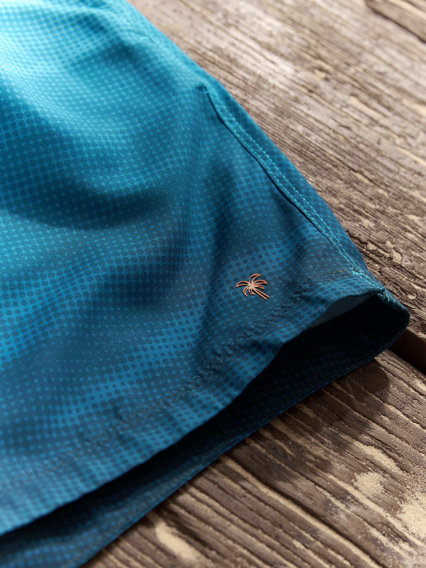 Buy Blue Textured Ombre Printed Swim Shorts from the Next UK online shop