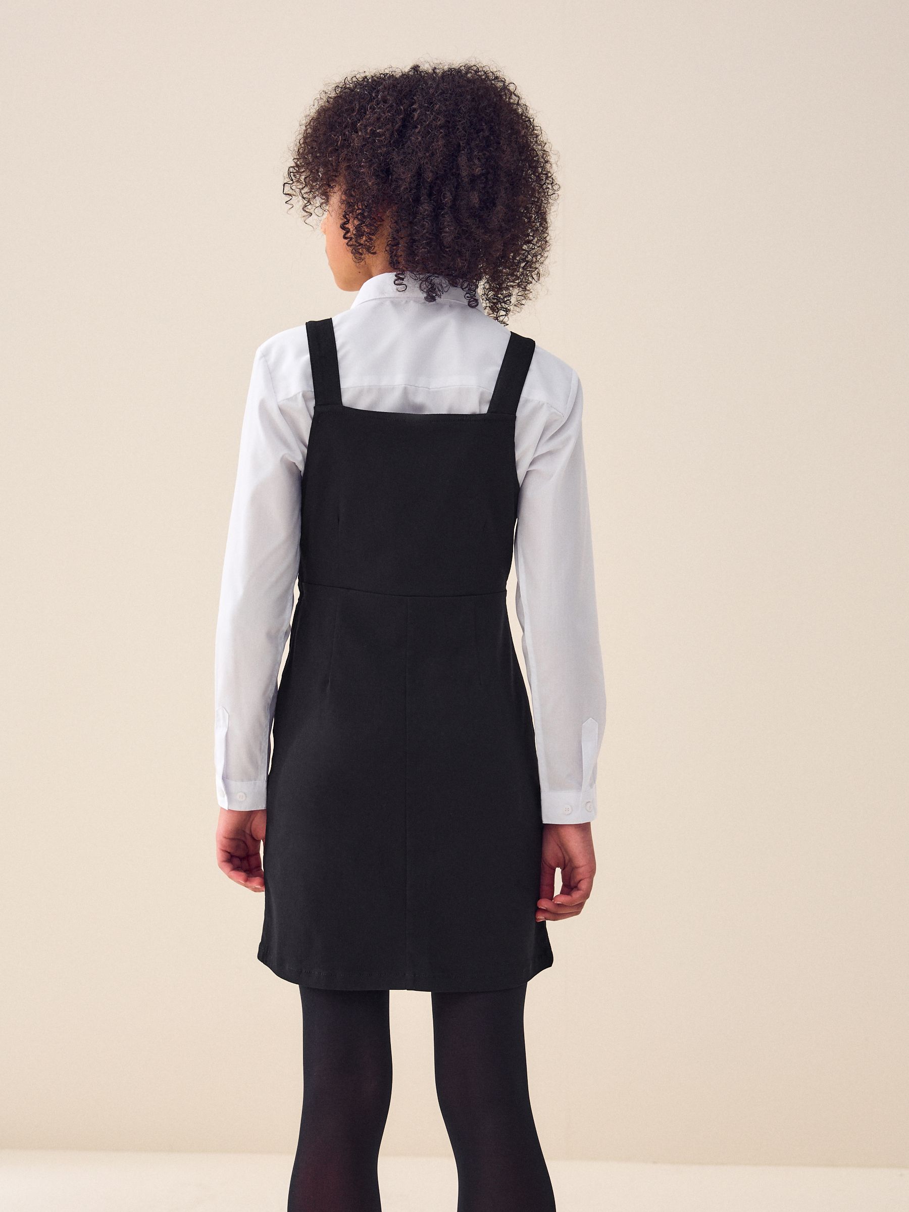 Buy Black Senior Stretch School Pinafore Dress (9-17yrs) from the Next ...