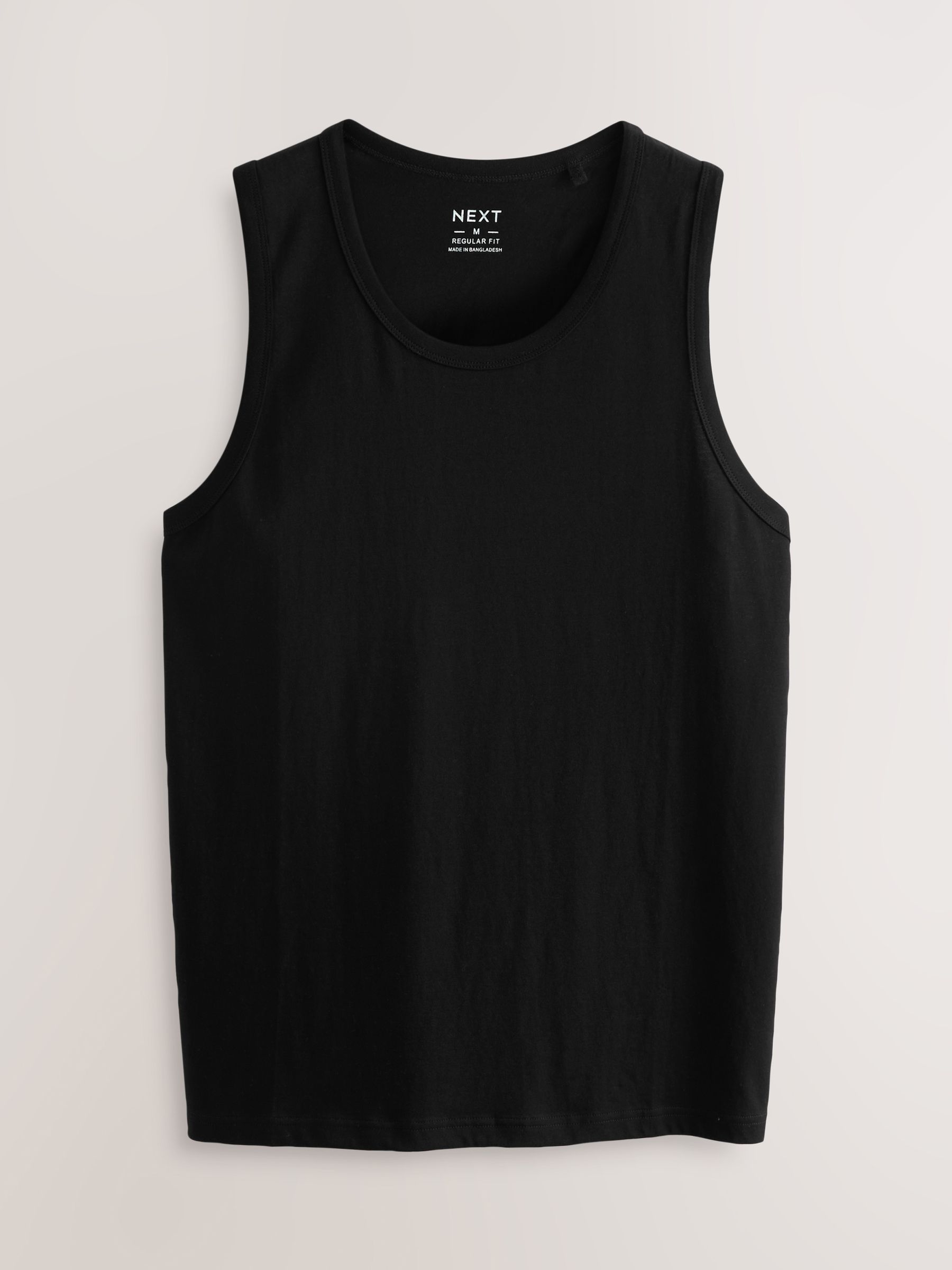Buy Black/Navy/White/Blue Cotton Vests 4 Pack from the Next UK online shop