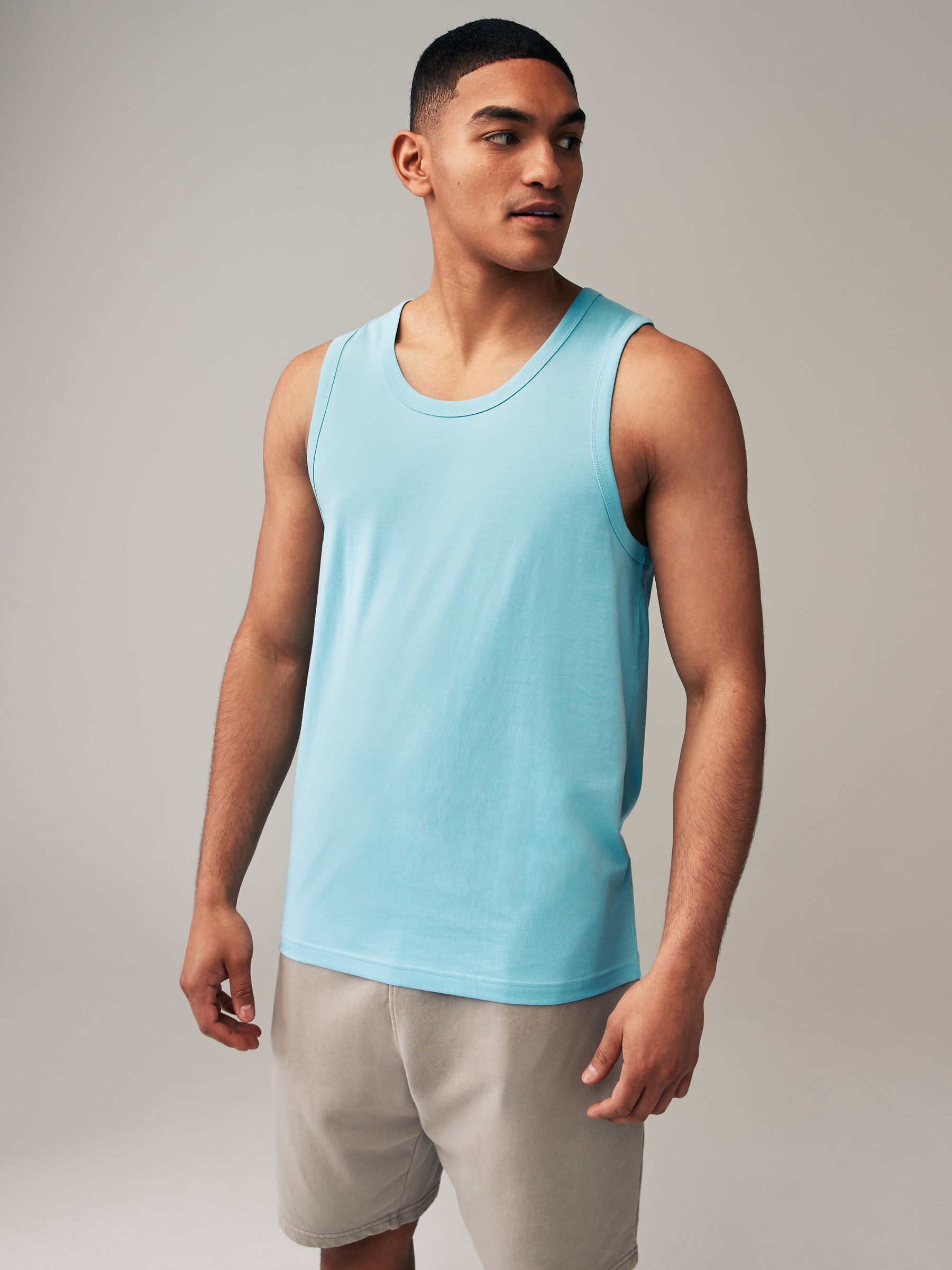 Buy Black/Navy/White/Blue Cotton Vests 4 Pack from the Next UK online shop