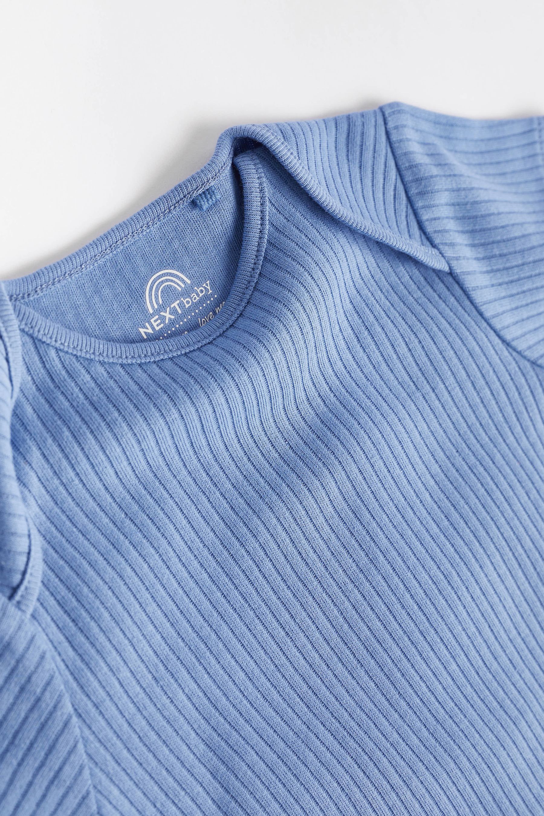 Buy Blue Plain Rib Baby Bodysuits 5 Pack from the Next UK online shop