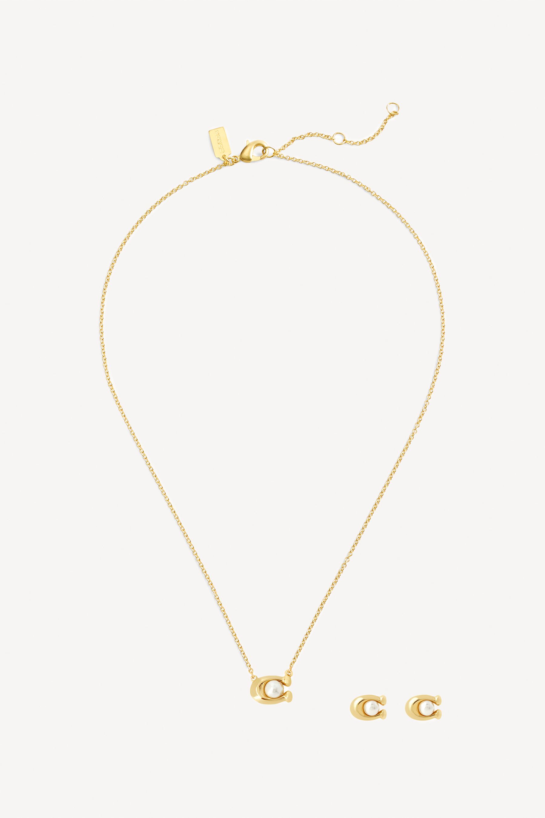Buy COACH Gold Tone Signature Pearl jewellery Set from the Next UK ...